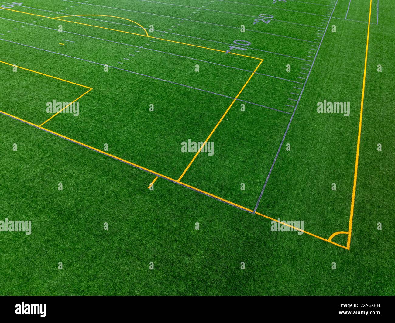 Late afternoon aerial photo of gray football line with yellow soccer ...