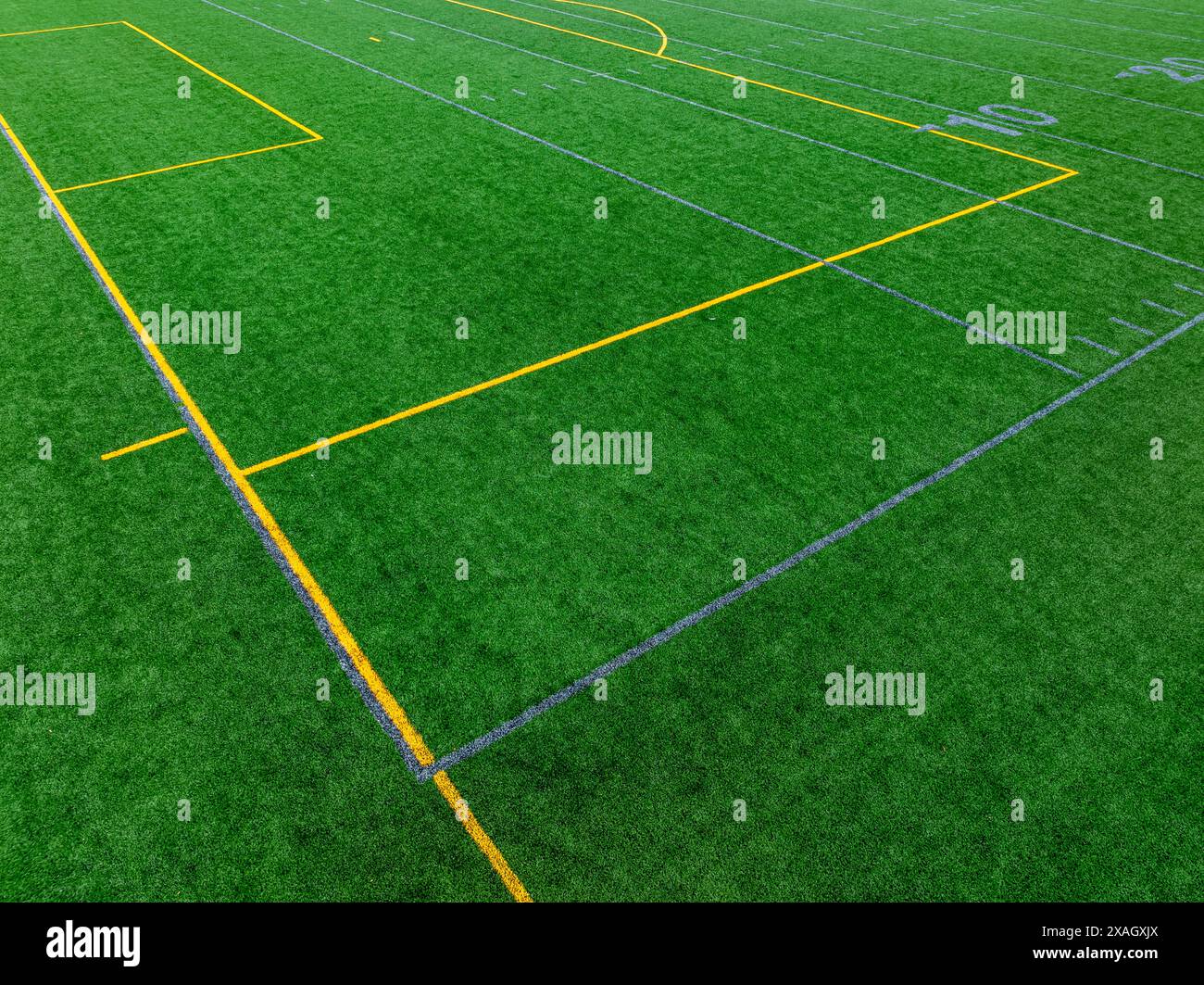 Late afternoon aerial photo of gray football line with yellow soccer ...