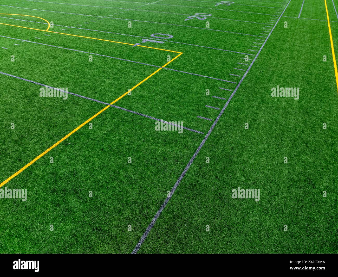 Late afternoon aerial photo of gray football line with yellow soccer ...