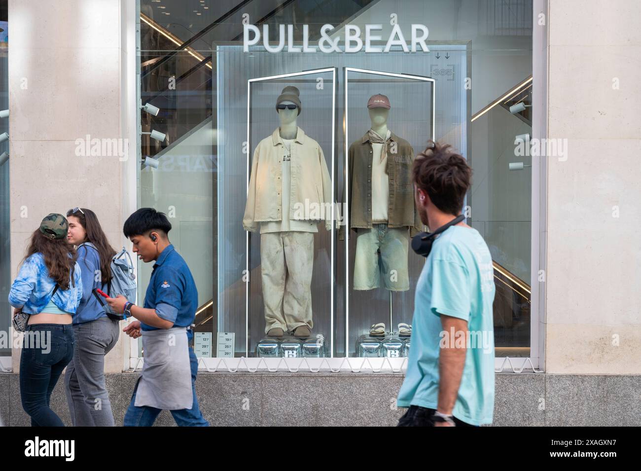 Madrid, Spain. 21st Apr, 2024. People walk past the Spanish ...