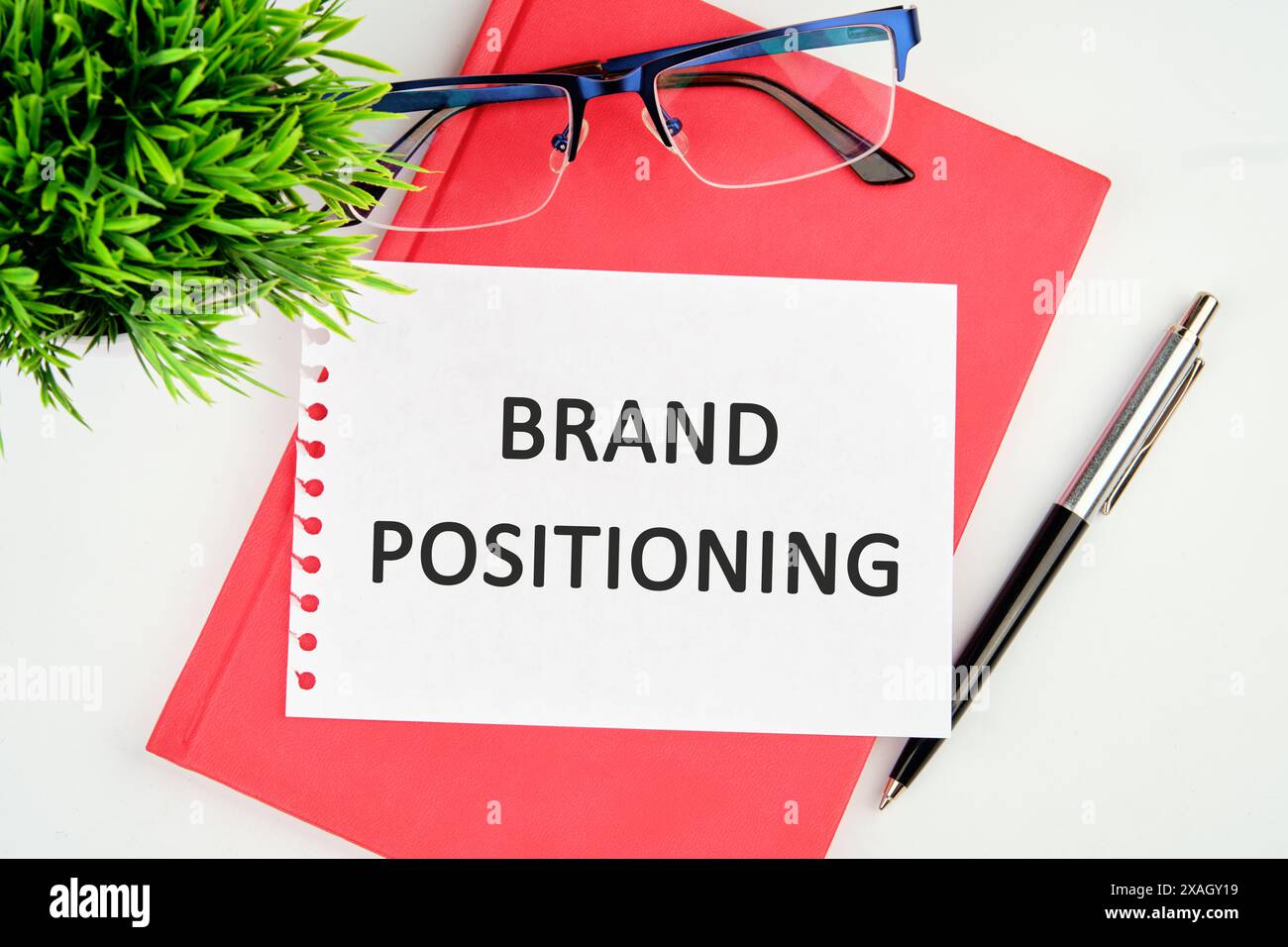 Business branding concept. BRAND POSITIONING text written on a torn ...