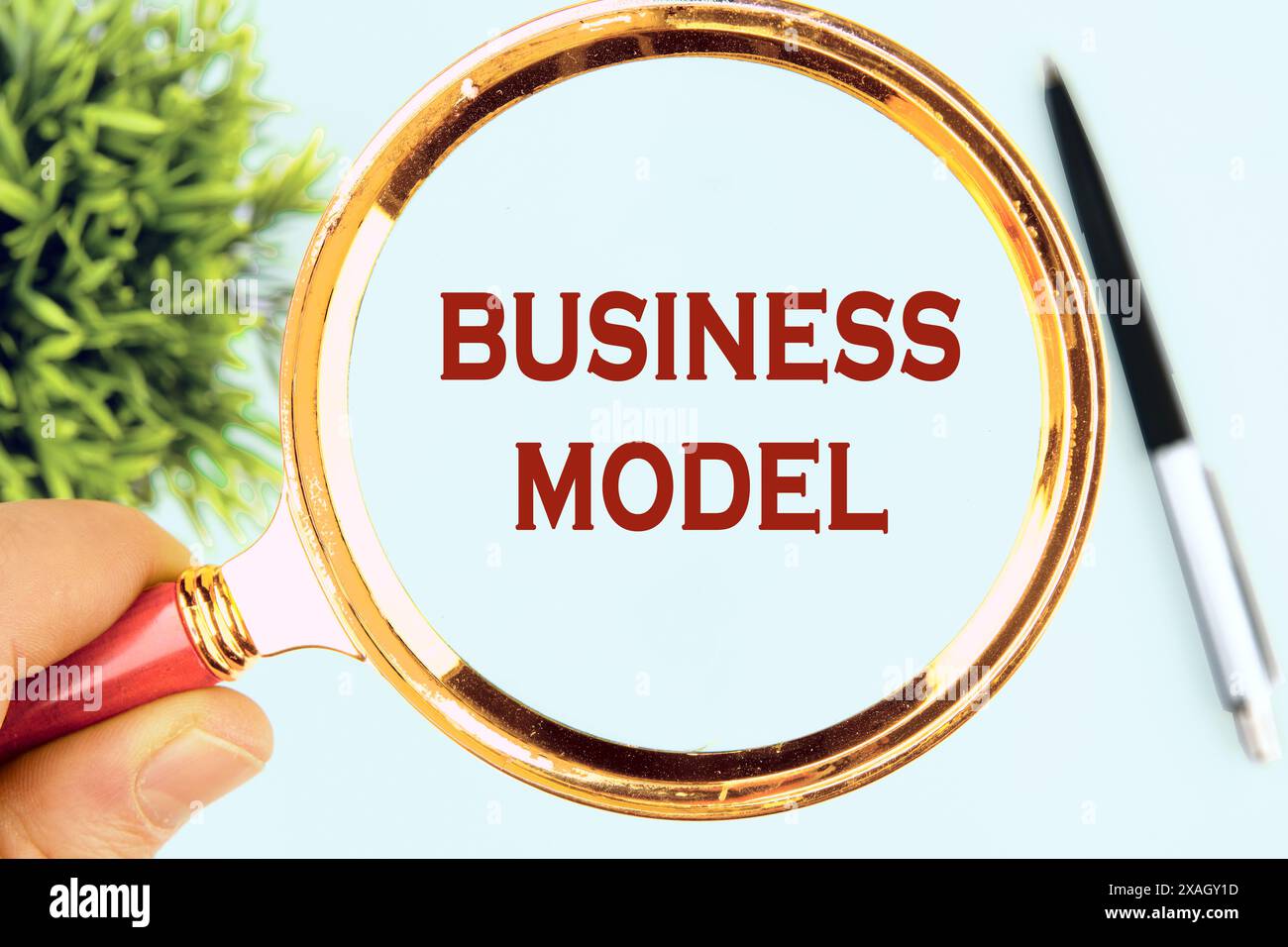 BUSINESS MODEL - Concept of text written through a magnifying glass on ...