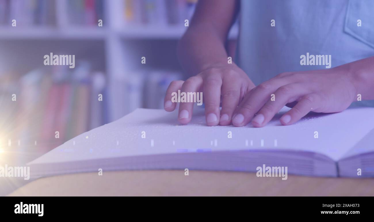 Image of light trails over biracial boy reading braille Stock Photo - Alamy