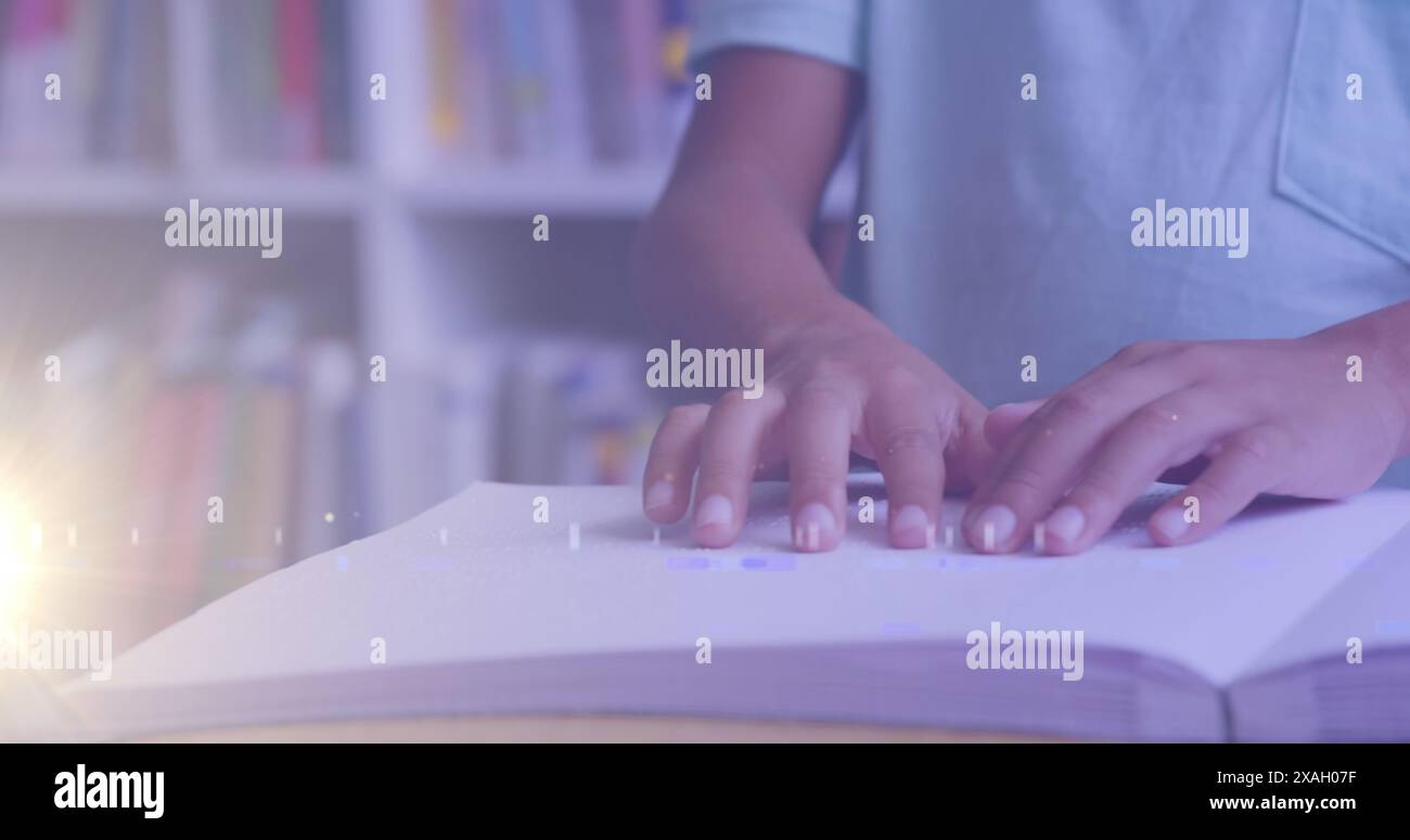 Image of light trails over biracial boy reading braille Stock Photo - Alamy