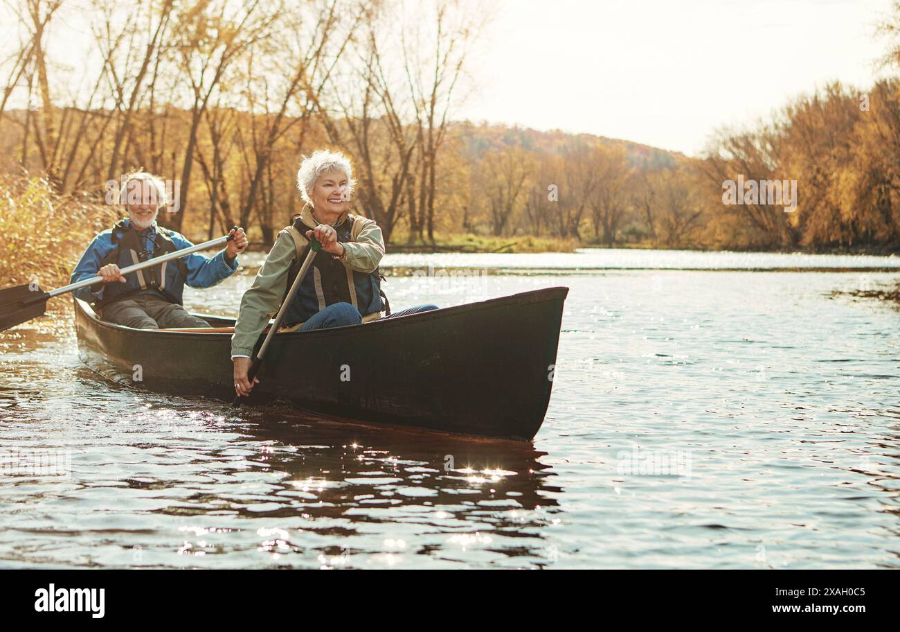 Lake, senior couple and rowing in nature with canoe for explore ...