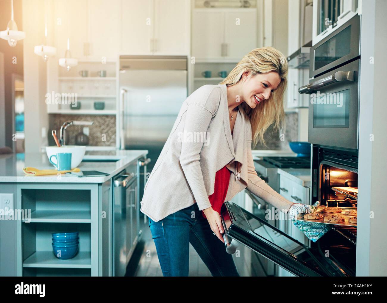 Happy, woman and baking cookies in kitchen for snack, lunch and ...