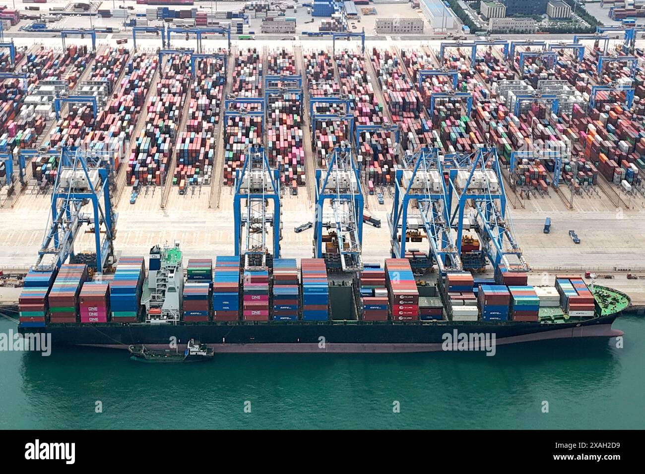 QINGDAO, CHINA - JUNE 7, 2024 - Cargo ships load and unload containers ...