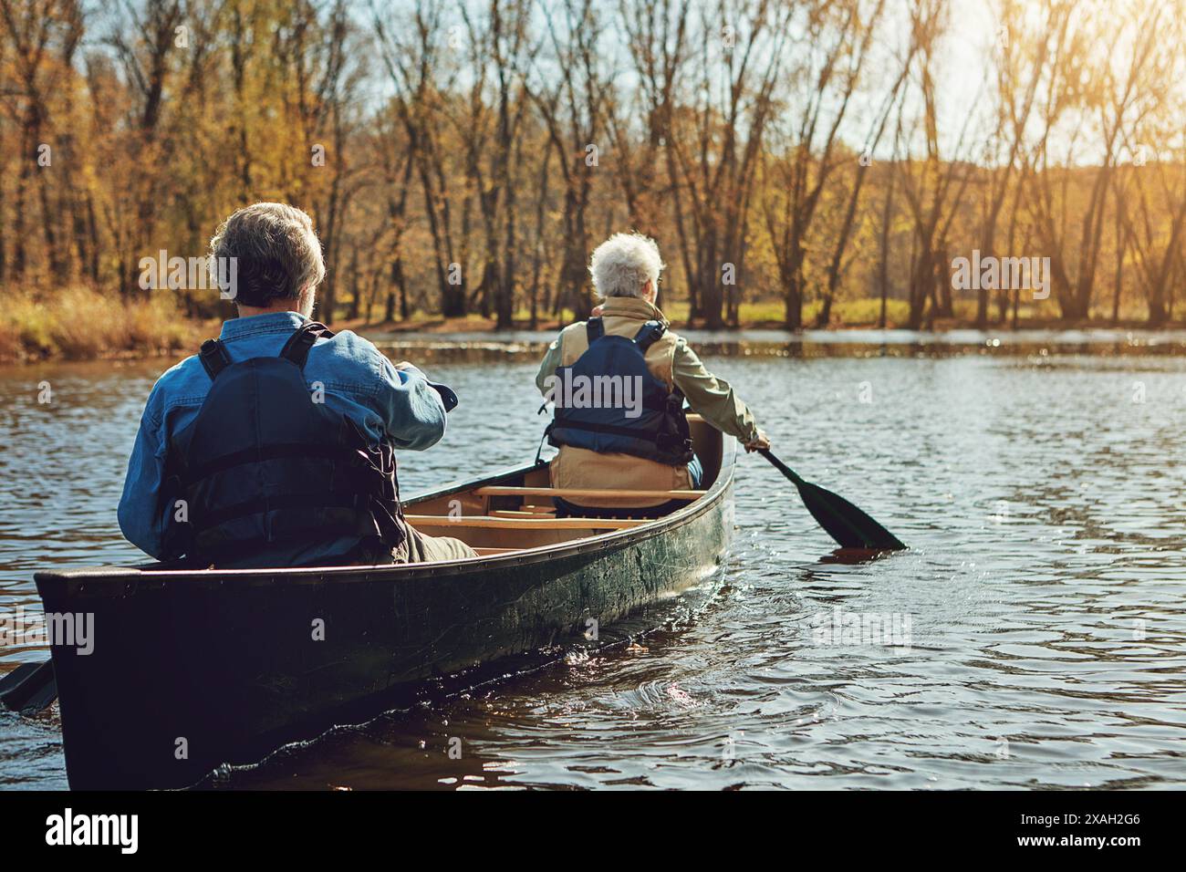 Senior couple, kayak and rowing in river for holiday, travel or summer ...