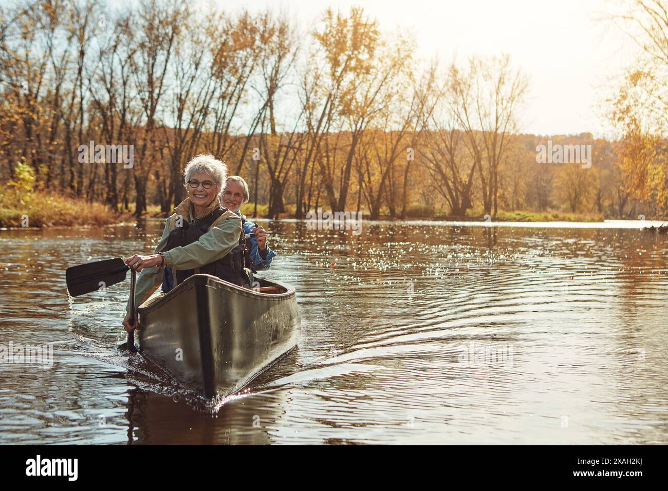 Lake, sunshine and kayak with old couple, nature and retirement with ...
