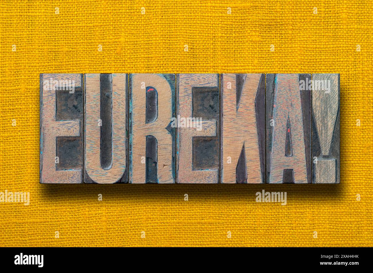 eureka exclamation from wooden letterpress on yellow linen Stock Photo ...