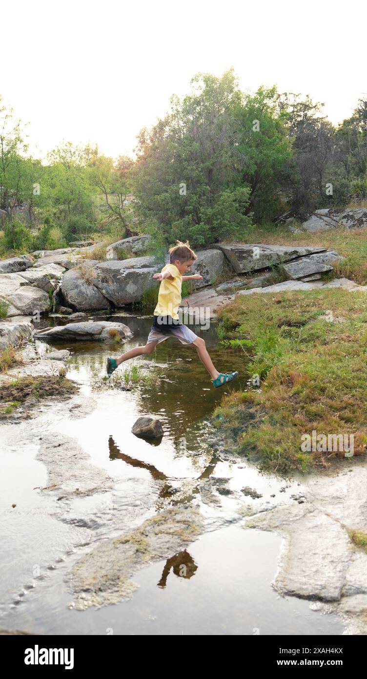 Jumping over stream hi-res stock photography and images - Alamy