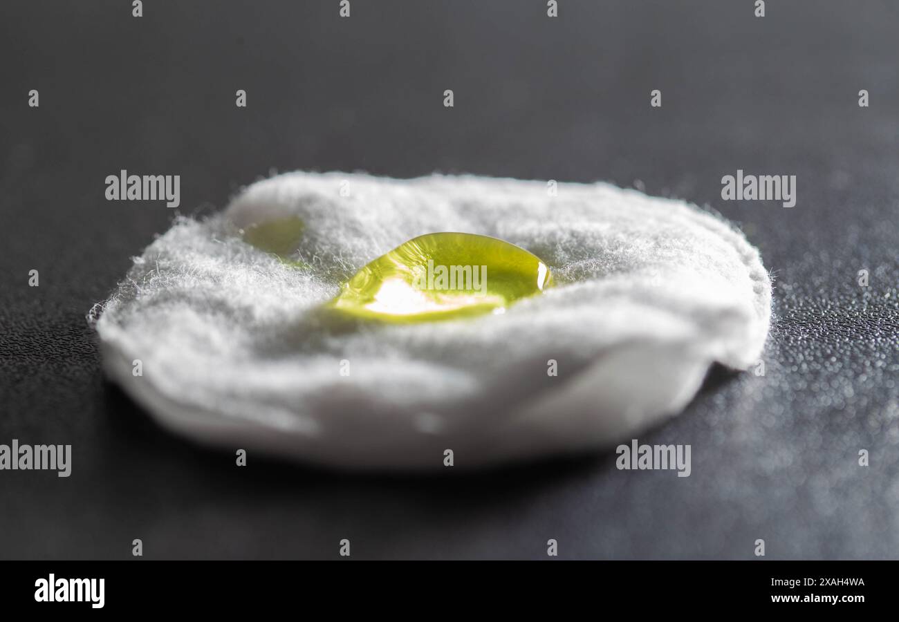 Modern yellow frost ointment on a white cotton pad. Cooling ointment ...