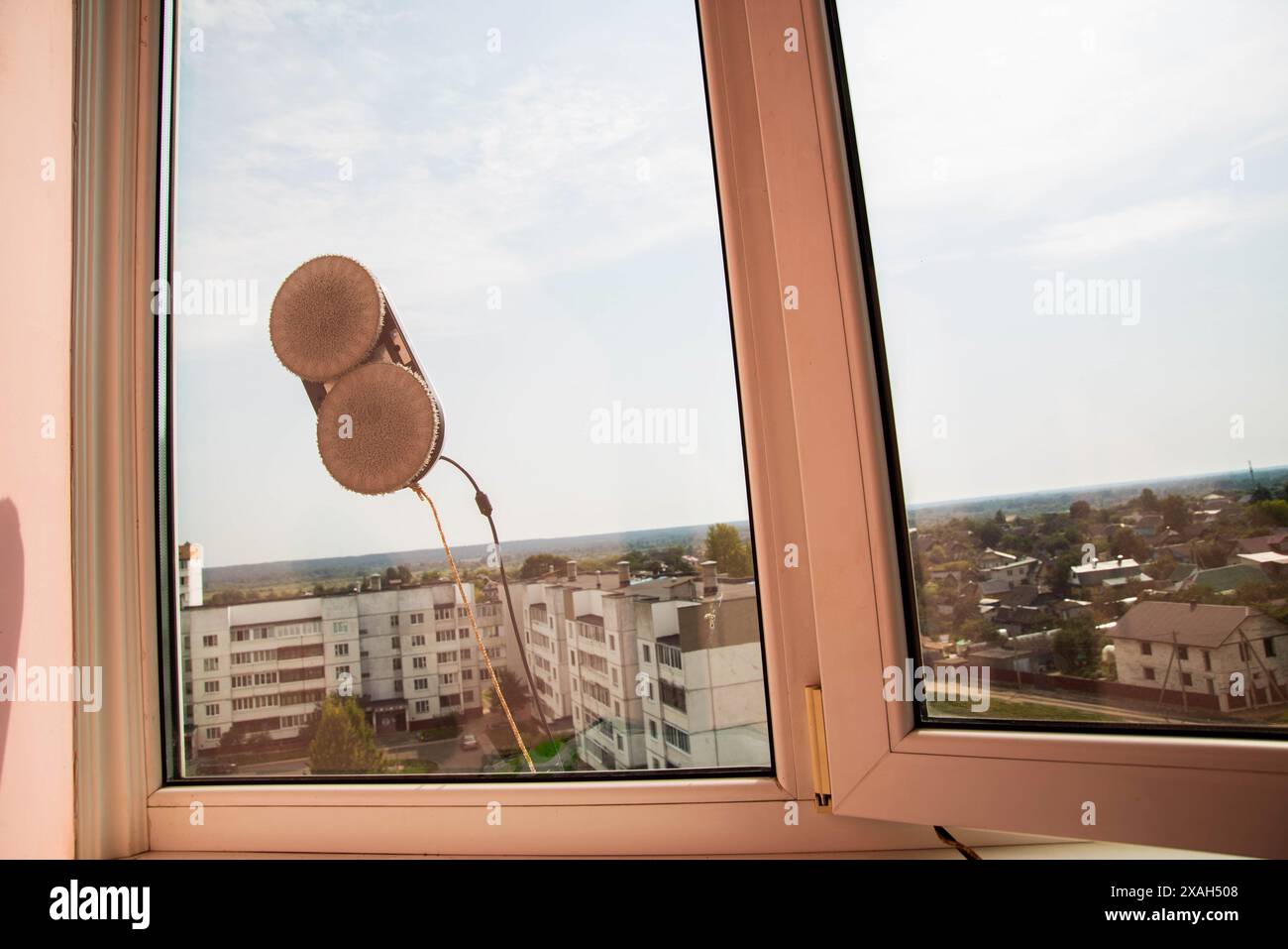 A modern vacuum robot window cleaner washes glass from dirt and stains ...