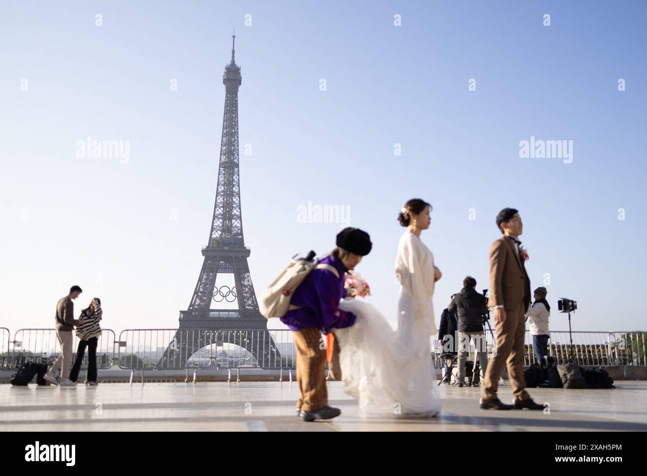 Paris, France. 07th June, 2024. Tourists pose in front of the Eiffel ...