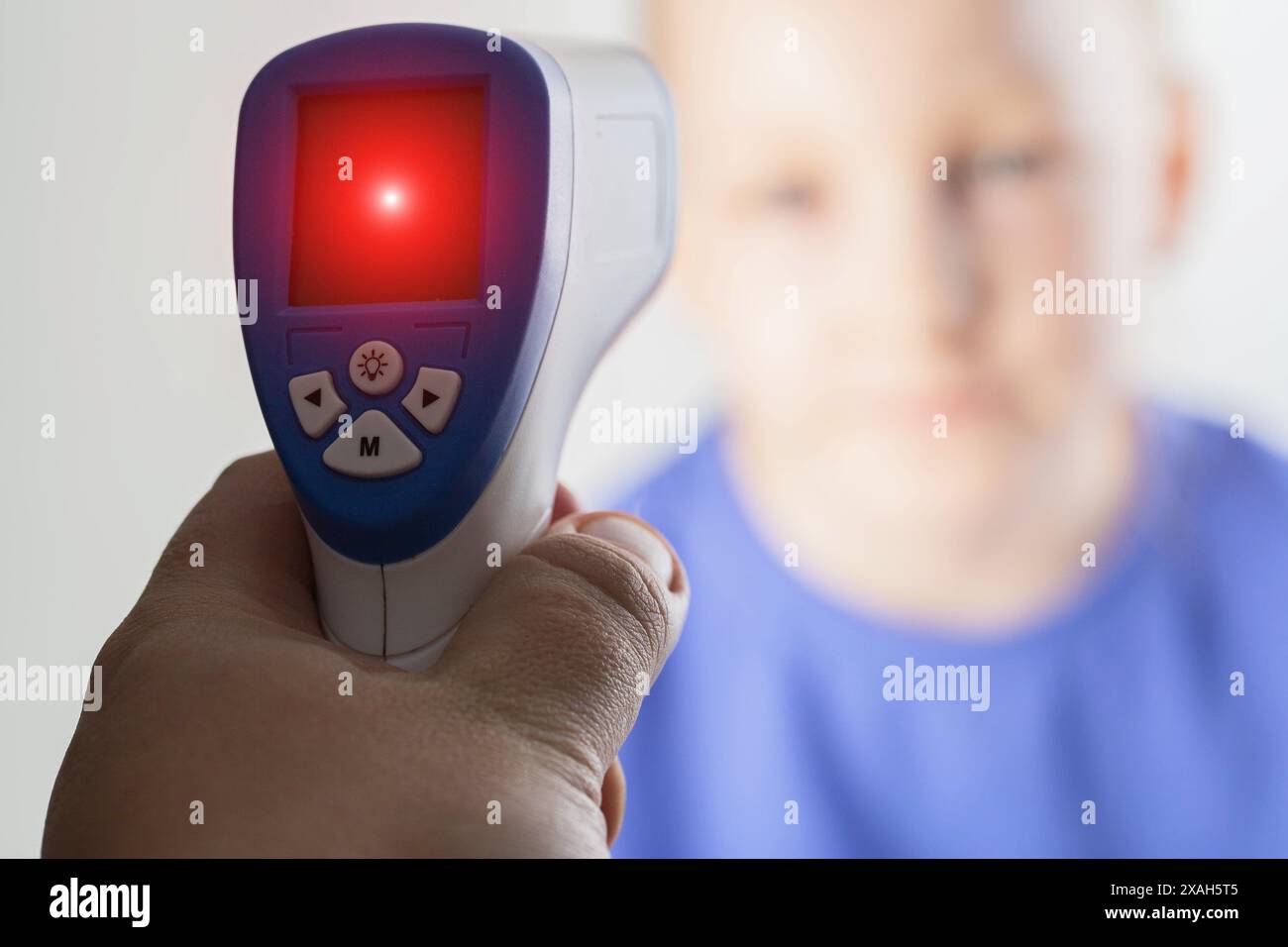 A red spot on a non-contact thermometer when measuring the body ...