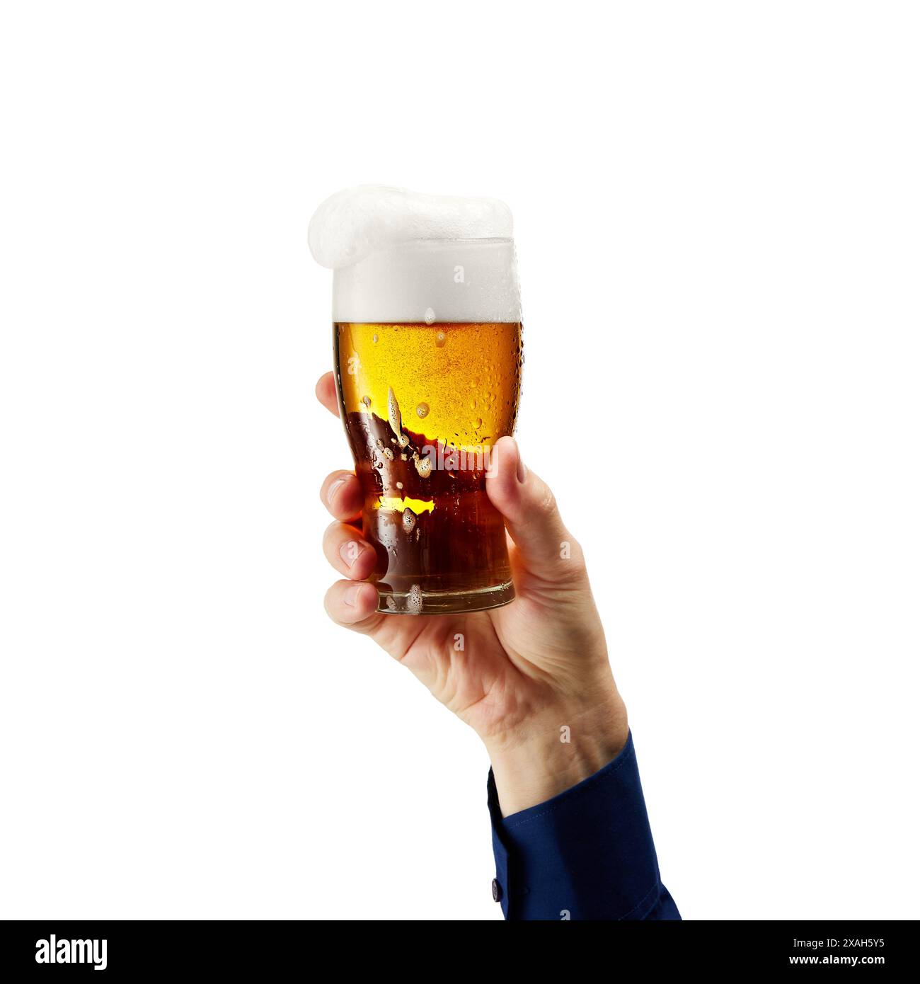 Traditional festival drink. Male hand holding glass with cool lager ...