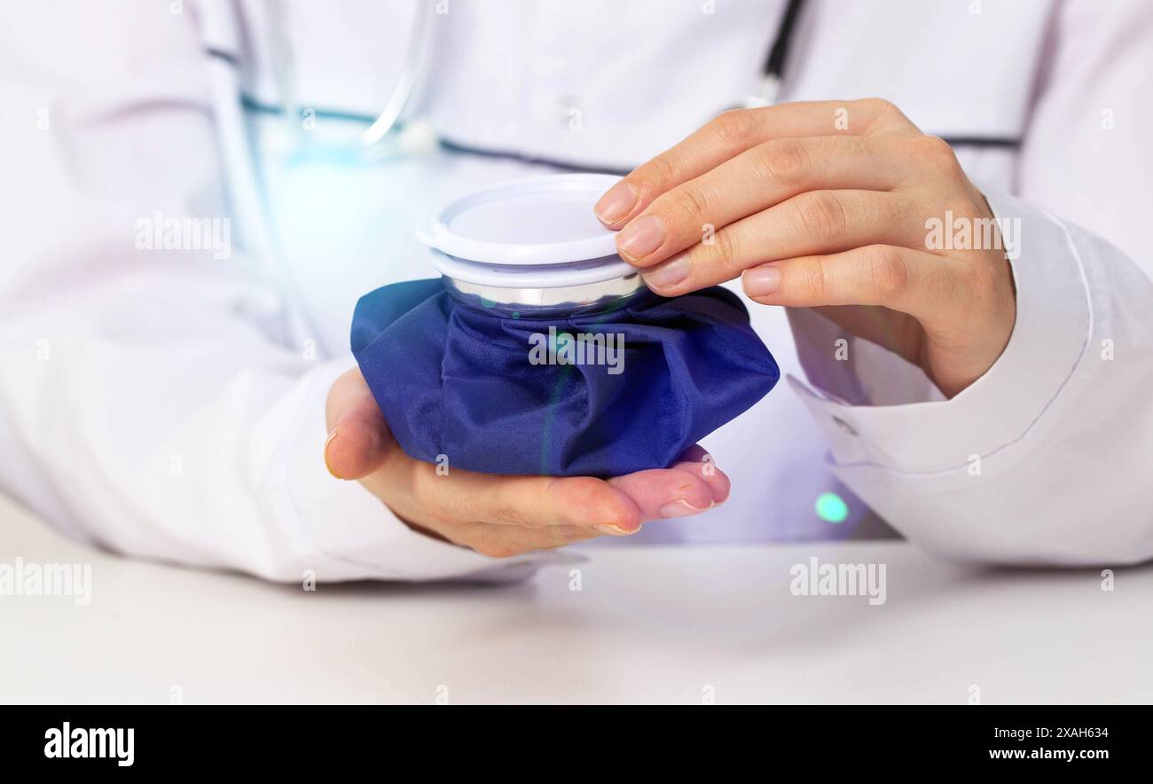 The doctor is holding a bag of ice in his hands. The concept of ...