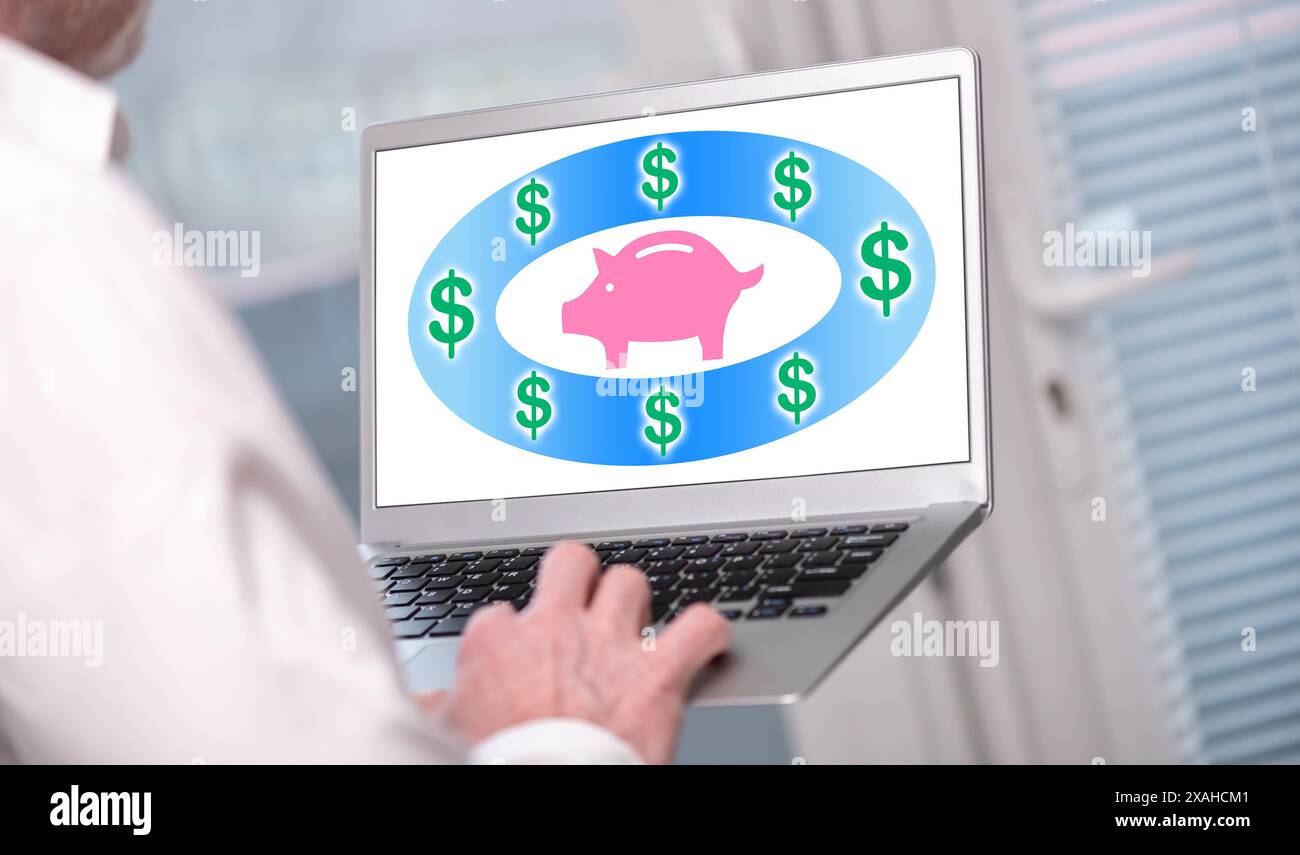 Saving money concept shown on a laptop used by a man Stock Photo - Alamy