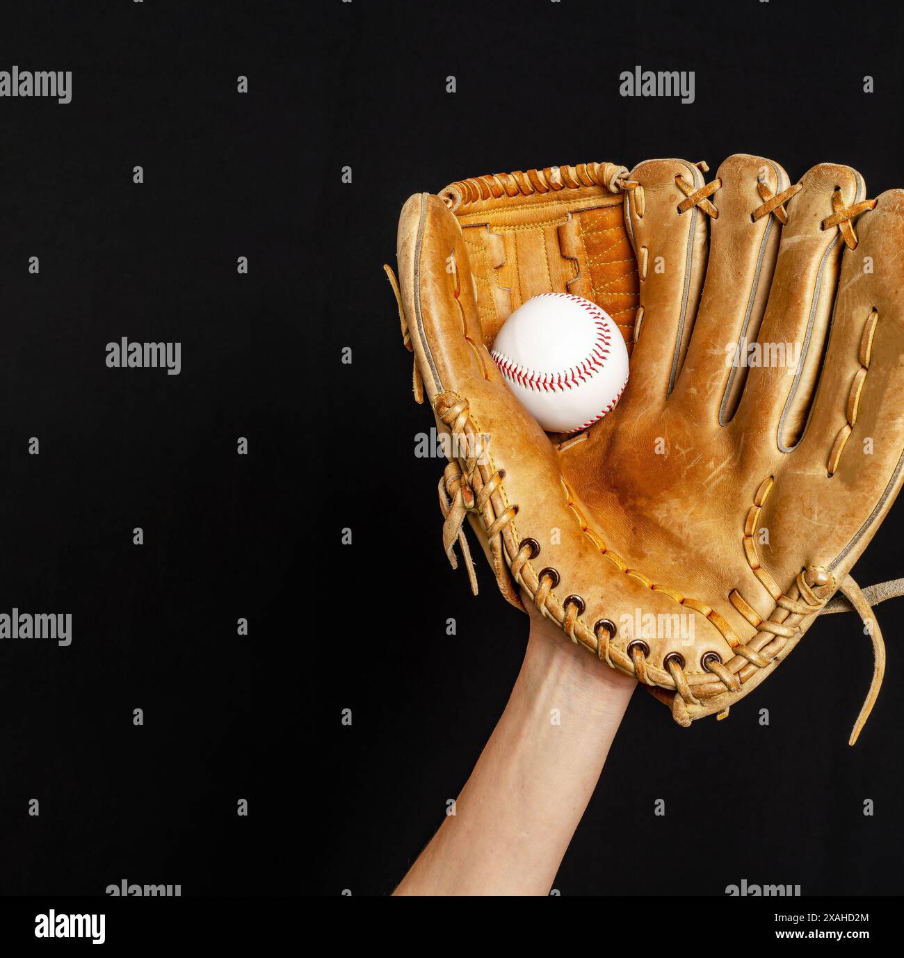 Baseball player hand with glove caught ball, isolated on black ...