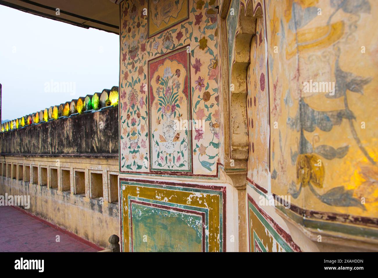 Colorful flower patterns are painted on the courtyard wall of the Amer ...