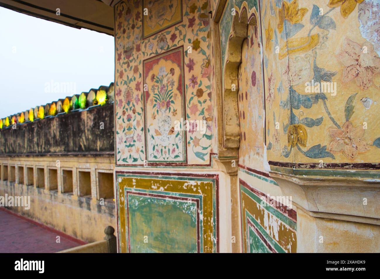 Colorful flower patterns are painted on the courtyard wall of the Amer ...