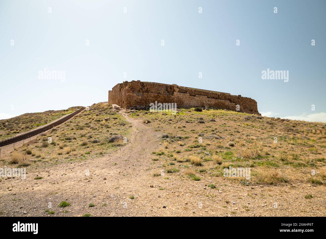 An ancient fortress on the hills, desert landscape, and clear blue sky ...