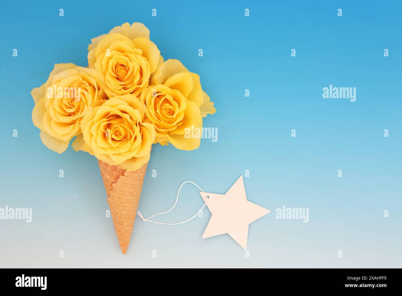 Surreal summer ice cream cone with yellow rose flowers on gradient blue ...