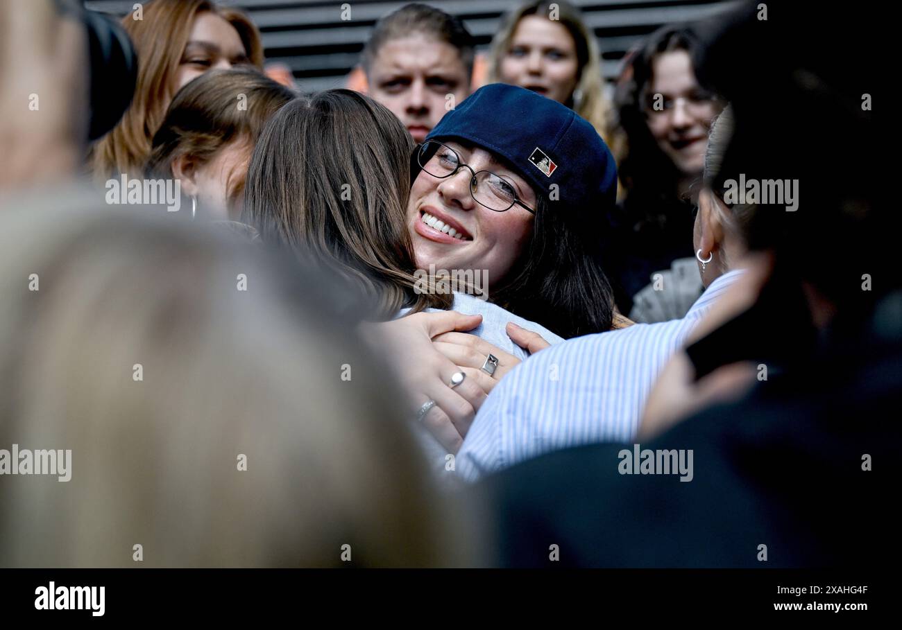 Berlin, Germany. 07th June, 2024. US singer Billie Eilish hugs a fan ...