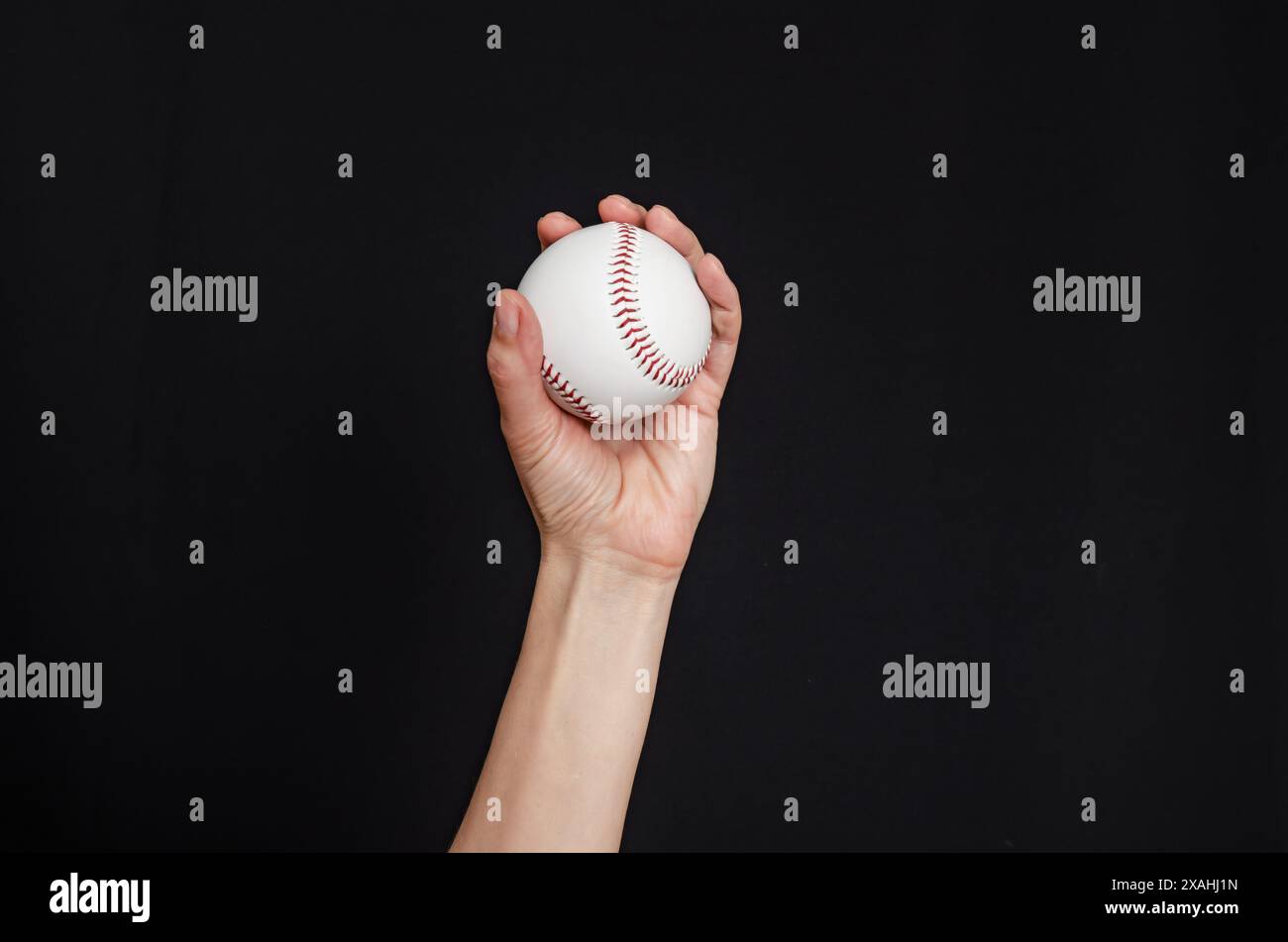 Hand holding a baseball on a black background. Baseball game concept ...