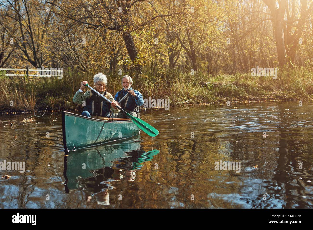 Senior couple, kayak and rowing for holiday, travel or summer vacation ...