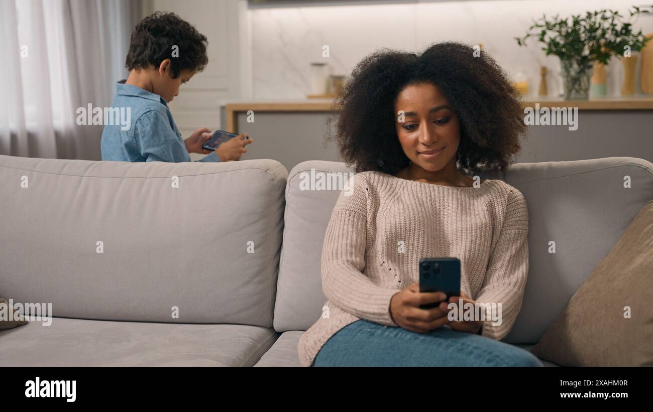 African American family young woman female mother mom chatting online ...