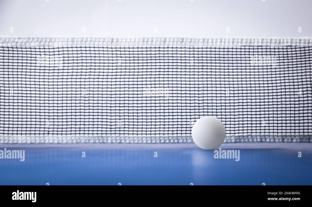 Ping pong background with white ball next to the net on a blue game ...