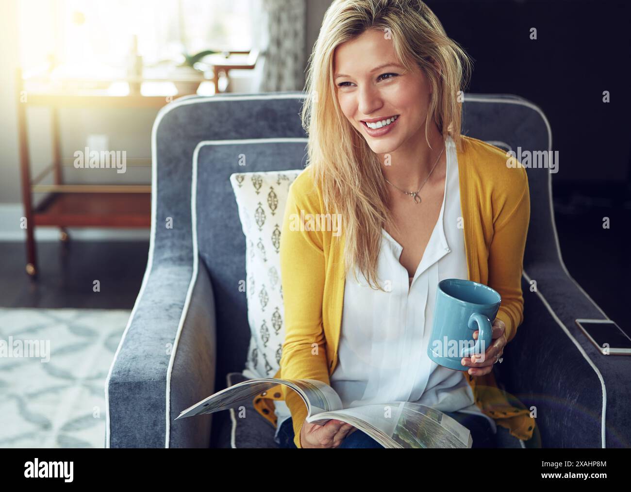 Happy woman, magazine and coffee break in reading, relax or thinking as ...