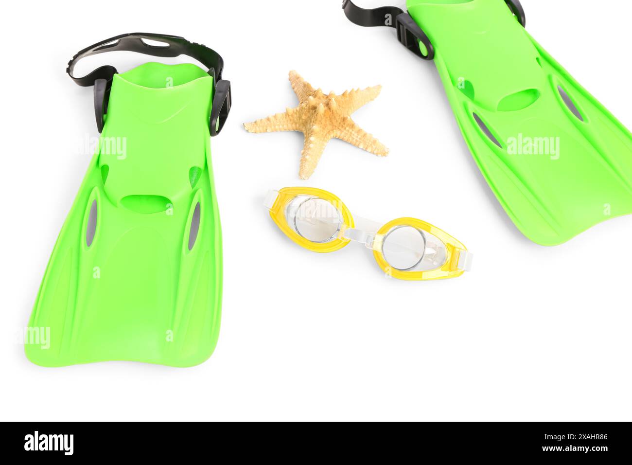 New swimming goggles, starfish and flippers on white background Stock ...