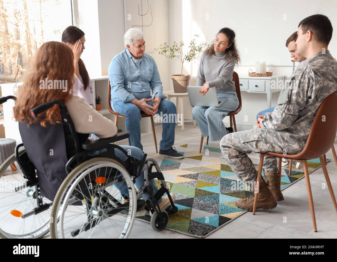Female psychologist talking at group therapy session Stock Photo - Alamy