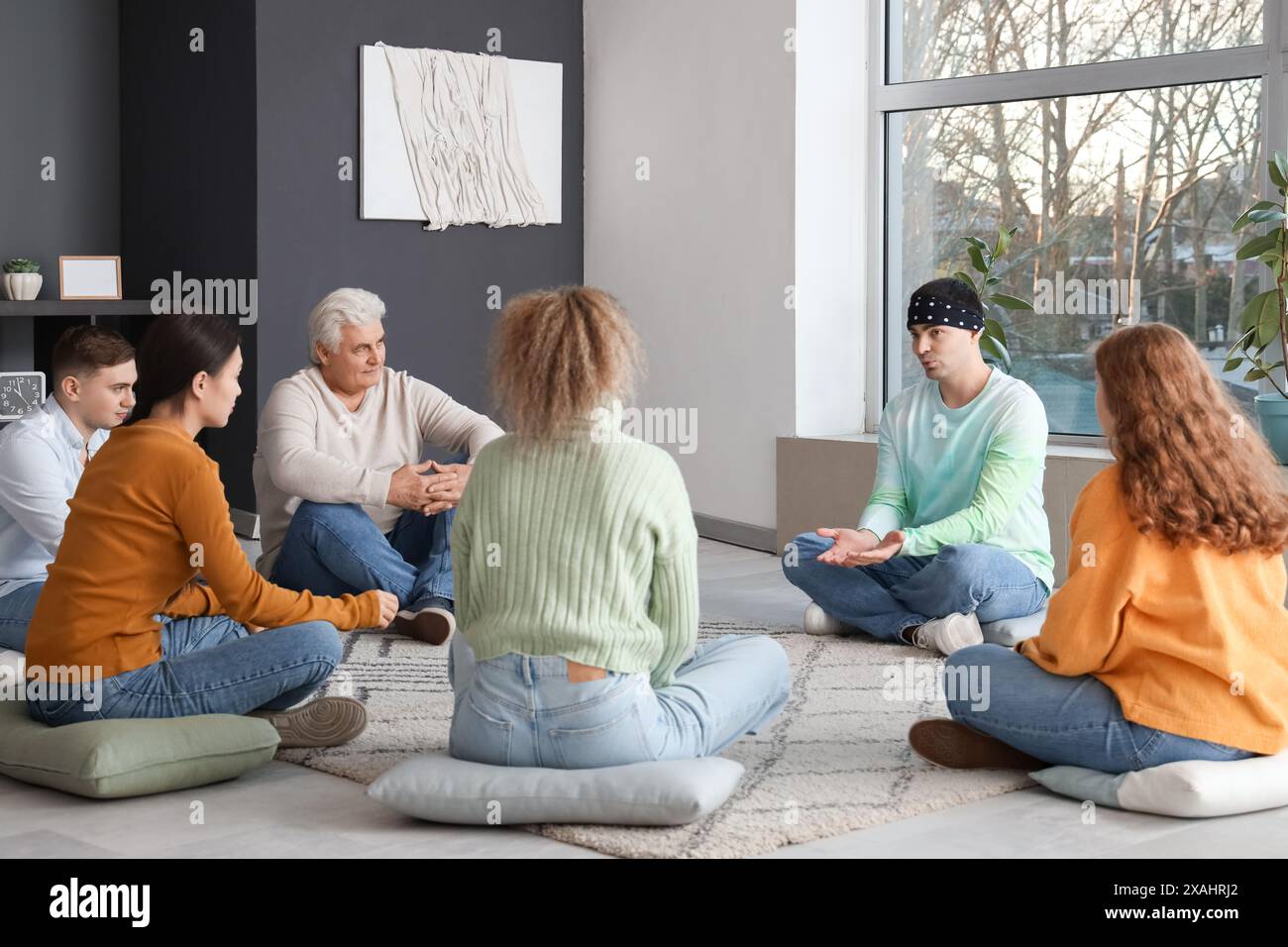People sitting on pillows at group therapy session Stock Photo - Alamy