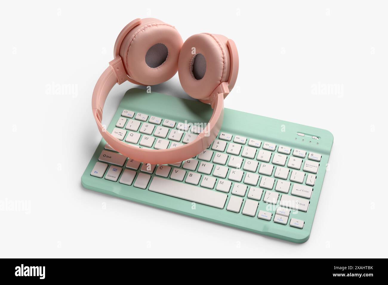 Wireless keyboard and headphones on white background Stock Photo - Alamy