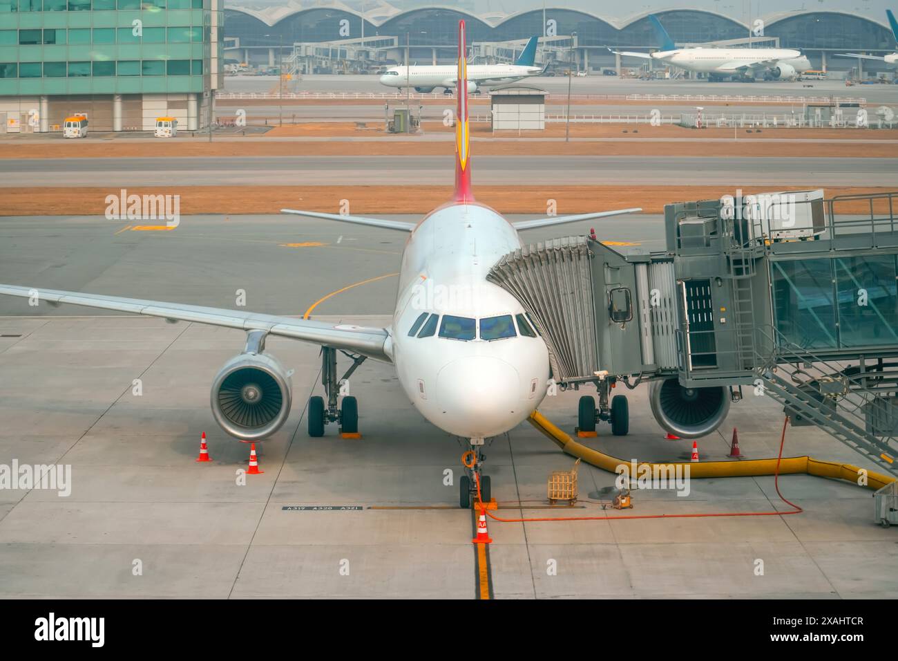 Front straight view of the body passenger airplane at the boarding ...