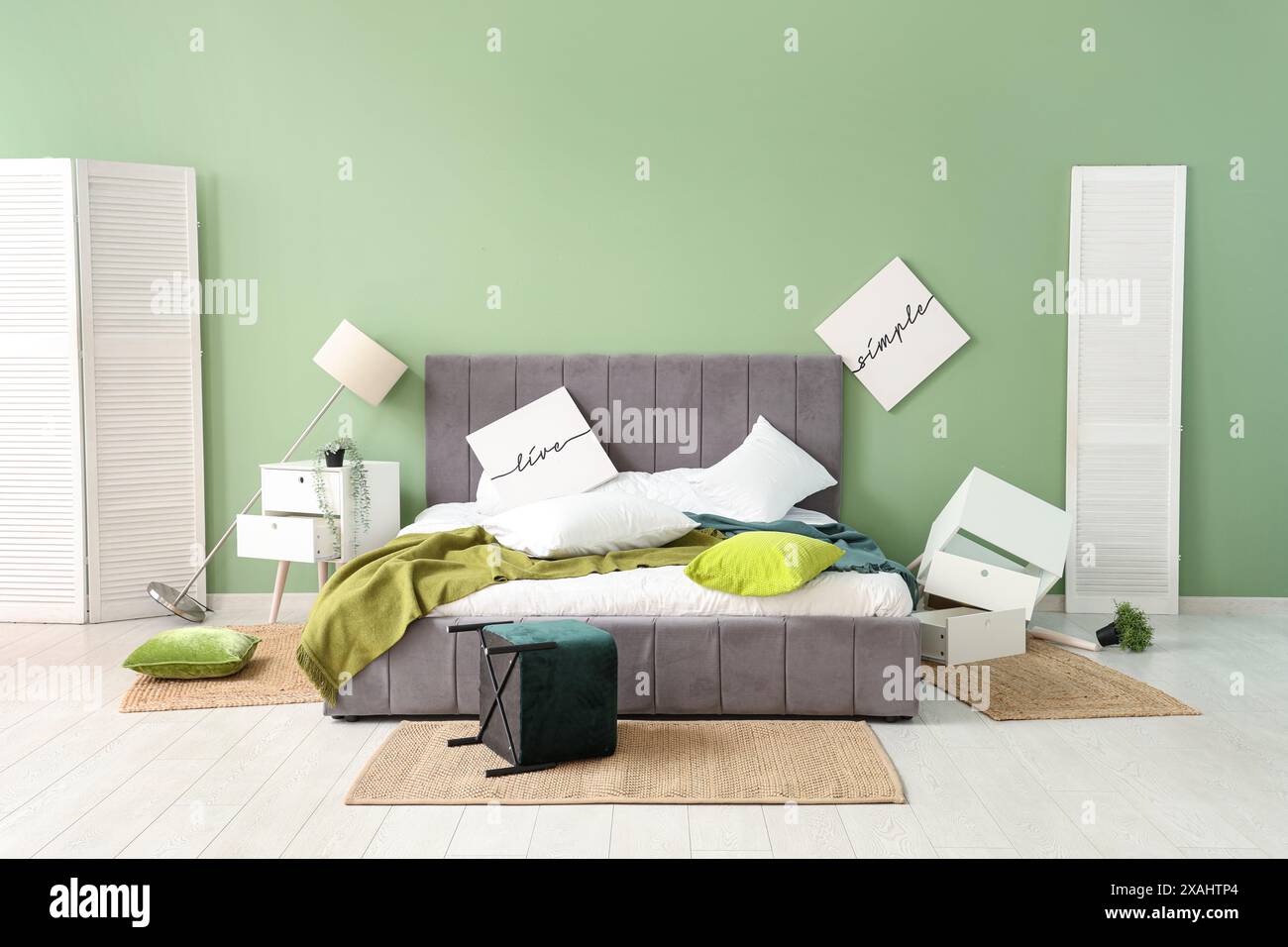 Interior of messy bedroom with posters and overturned pouf Stock Photo ...