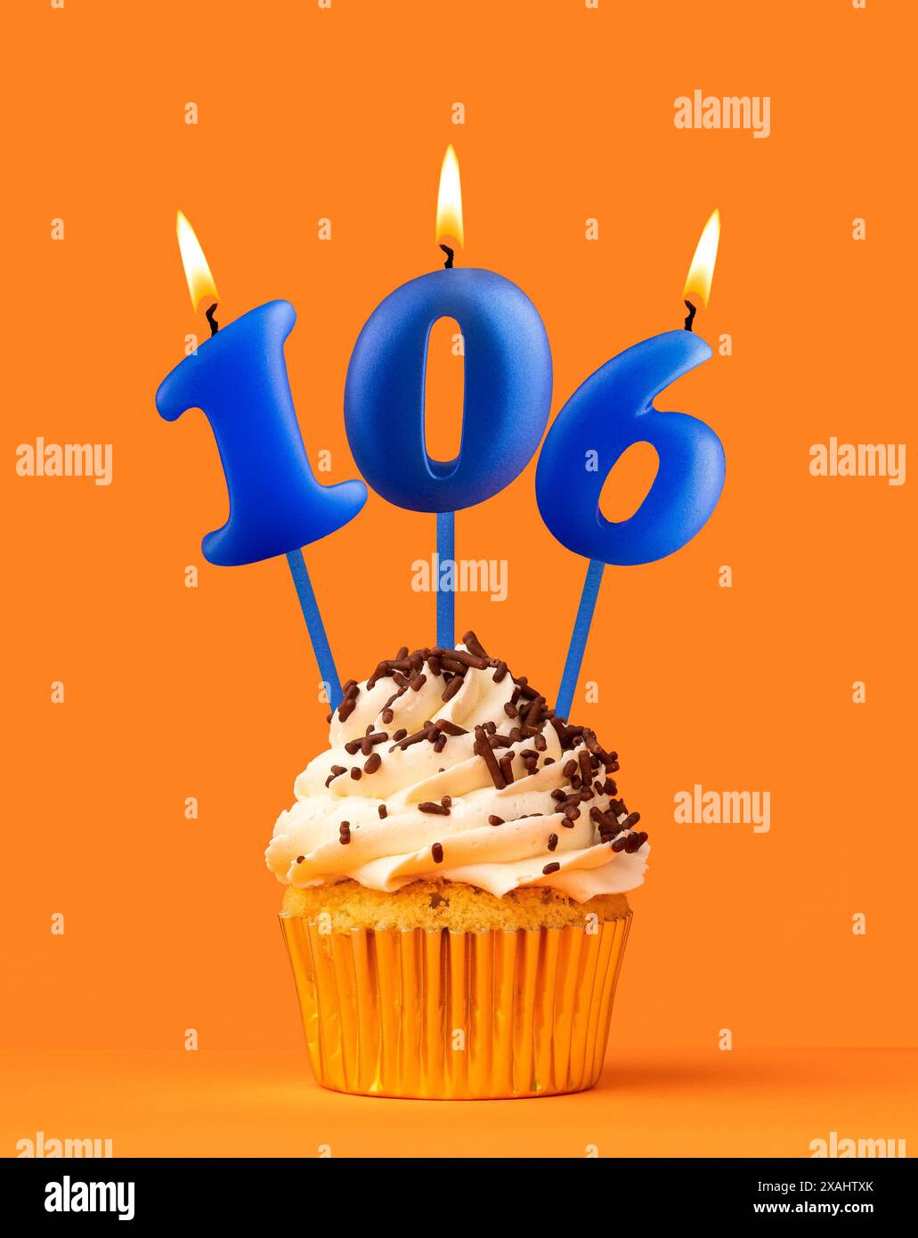 Blue birthday candle and cupcake - Number 106 Stock Photo - Alamy