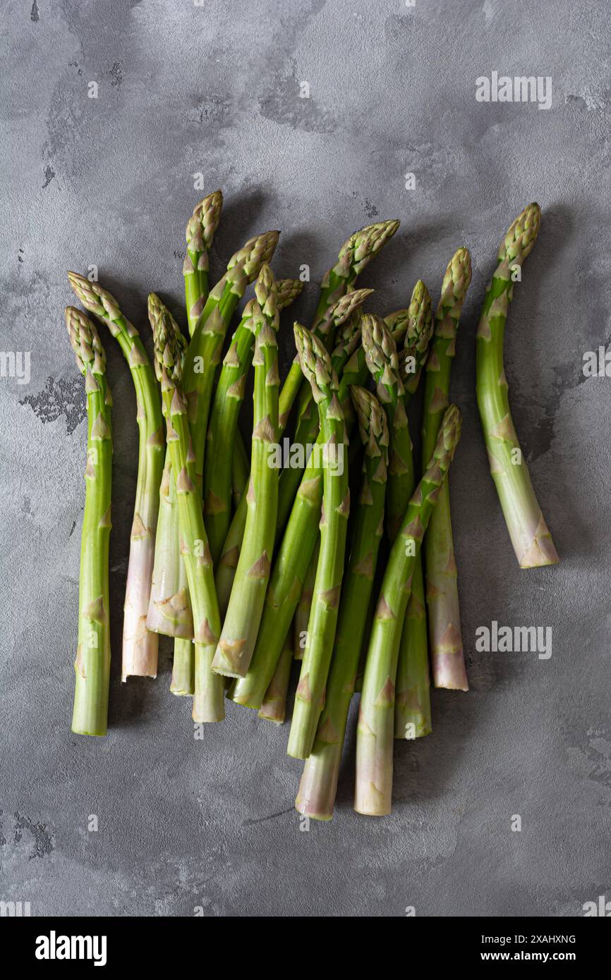 Fresh asparagus sprouts on a gray background. The concept of healthy ...