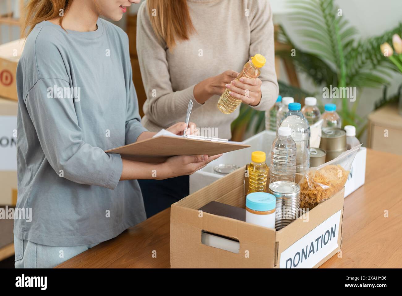 Volunteer Organizing Food Donations in Boxes for Charity - Community ...
