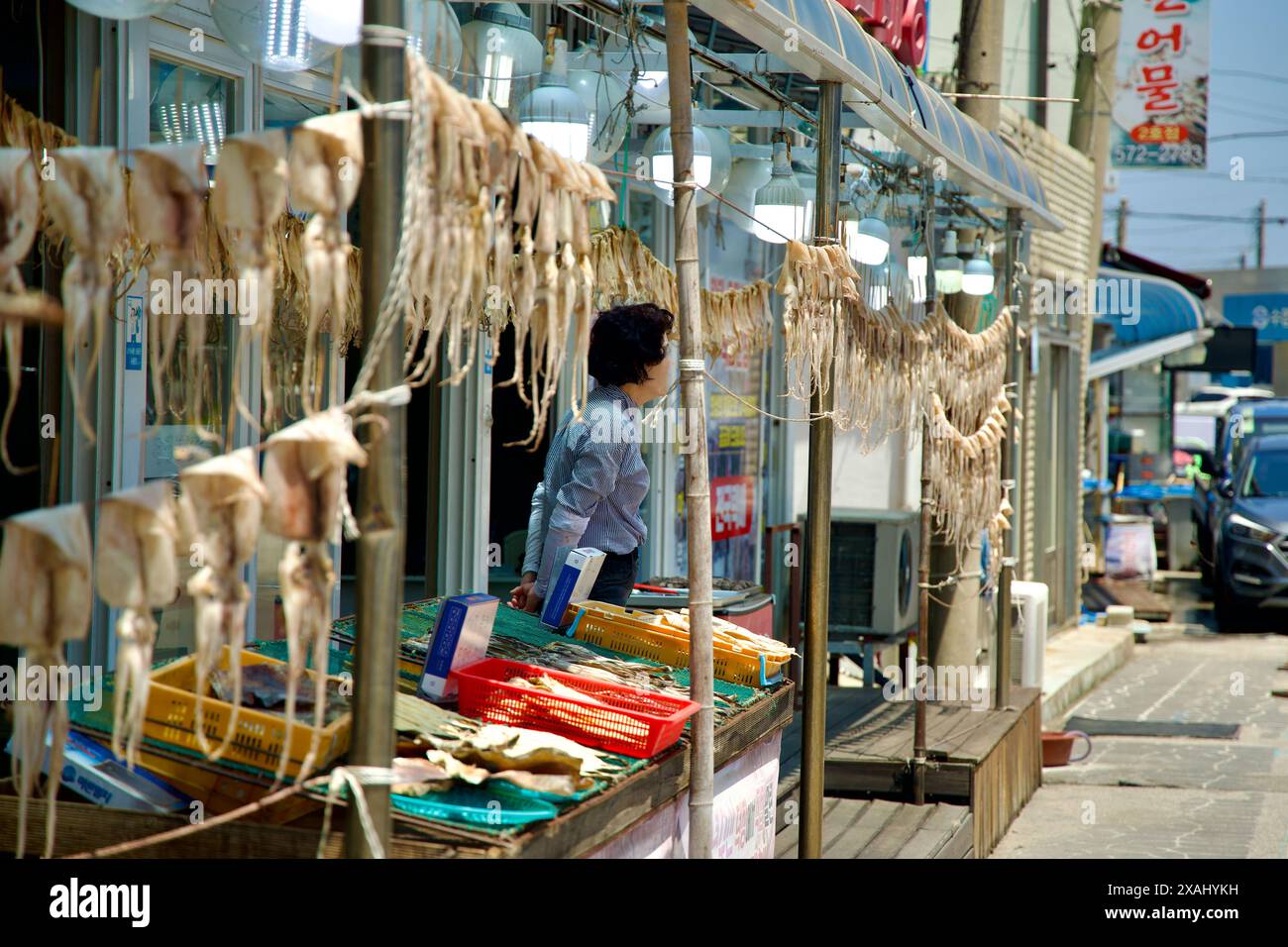 Samcheok City, South Korea - May 18, 2024: A vendor standing beside ...