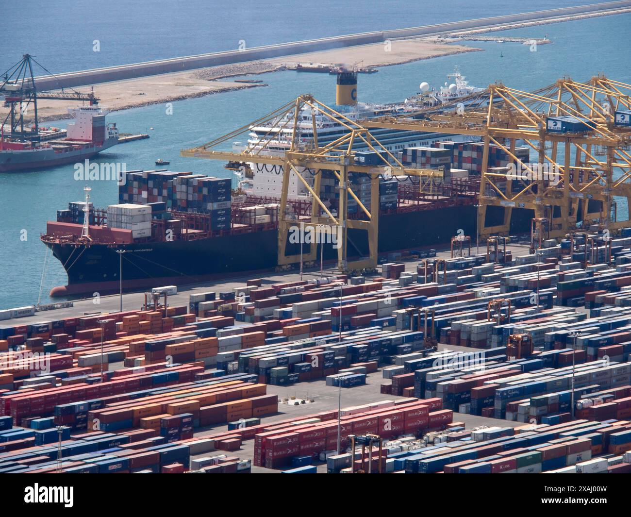 A large container ship in the harbour, surrounded by many containers ...