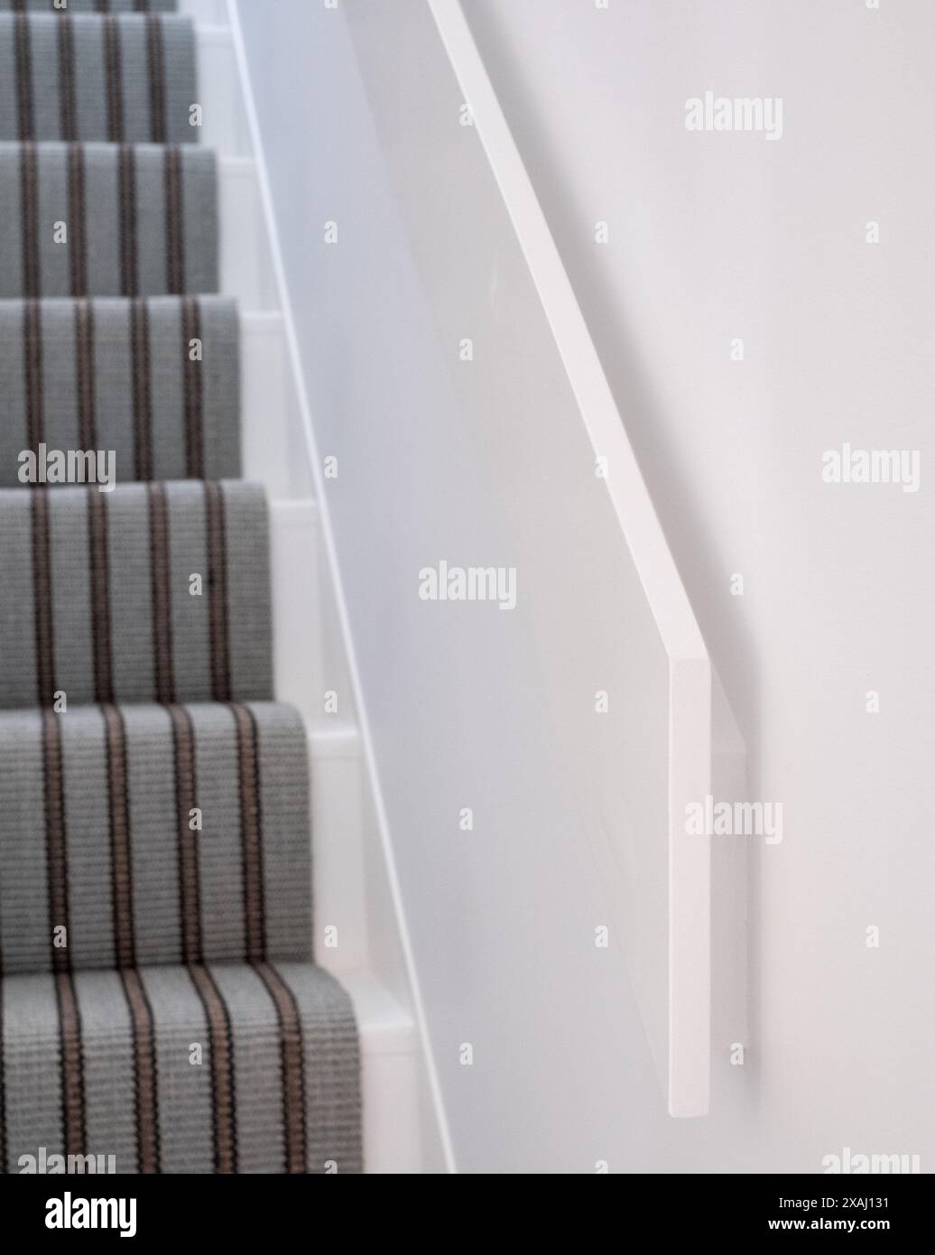 Minimalist, white painted MDF handrail banister, grey and tan striped ...