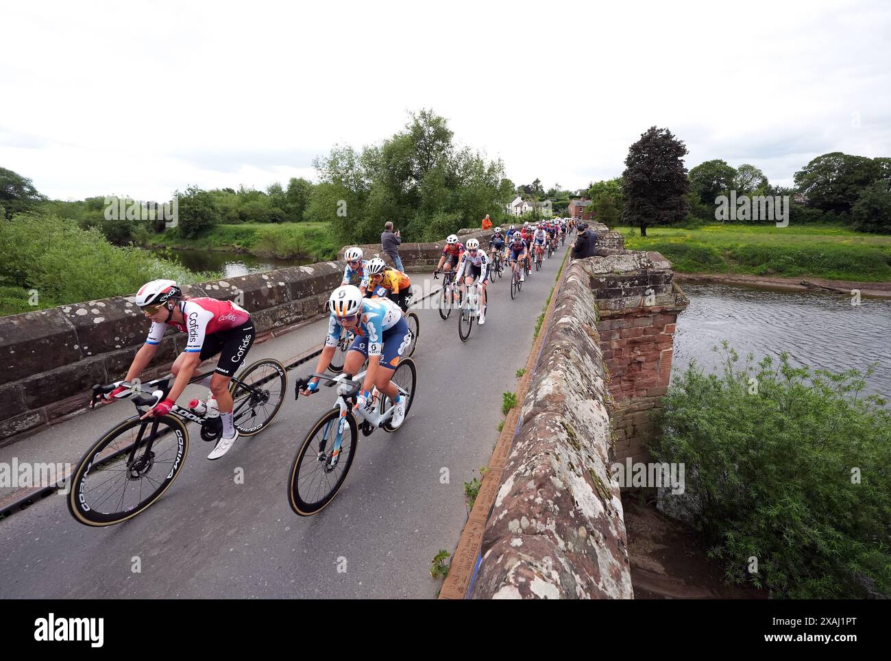 The peleton passes over Farndon Bridge during stage two of the Lloyds ...