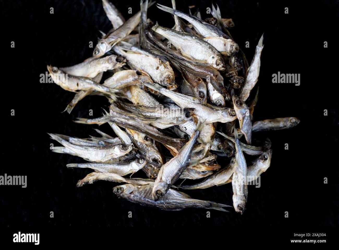 Small fish dried in salt. Indonesian spices. Dried fish and anchovies ...
