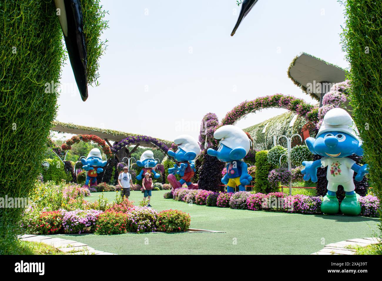 A line of colorful Smurf statues standing in Dubai Miracle Garden, UAE ...