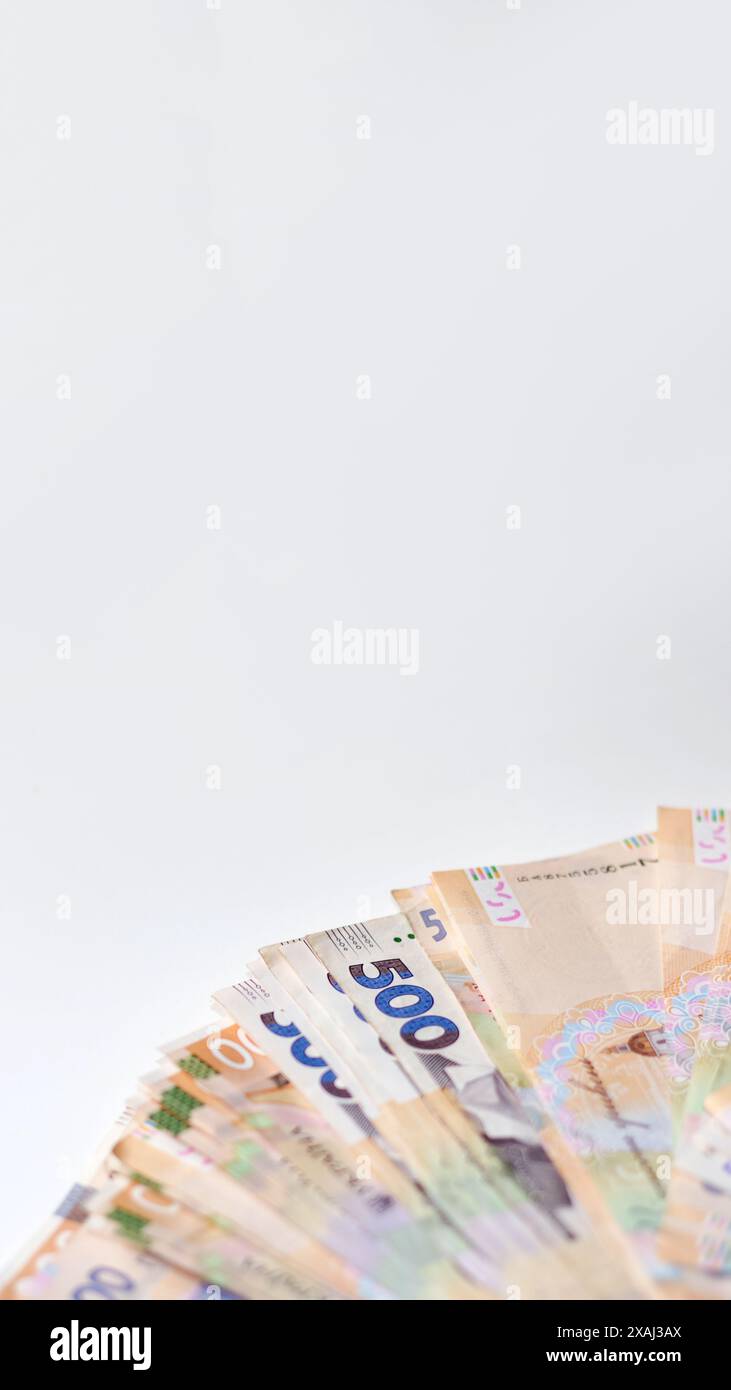 Vertical image of money, Ukrainian hryvnia banknotes on white ...