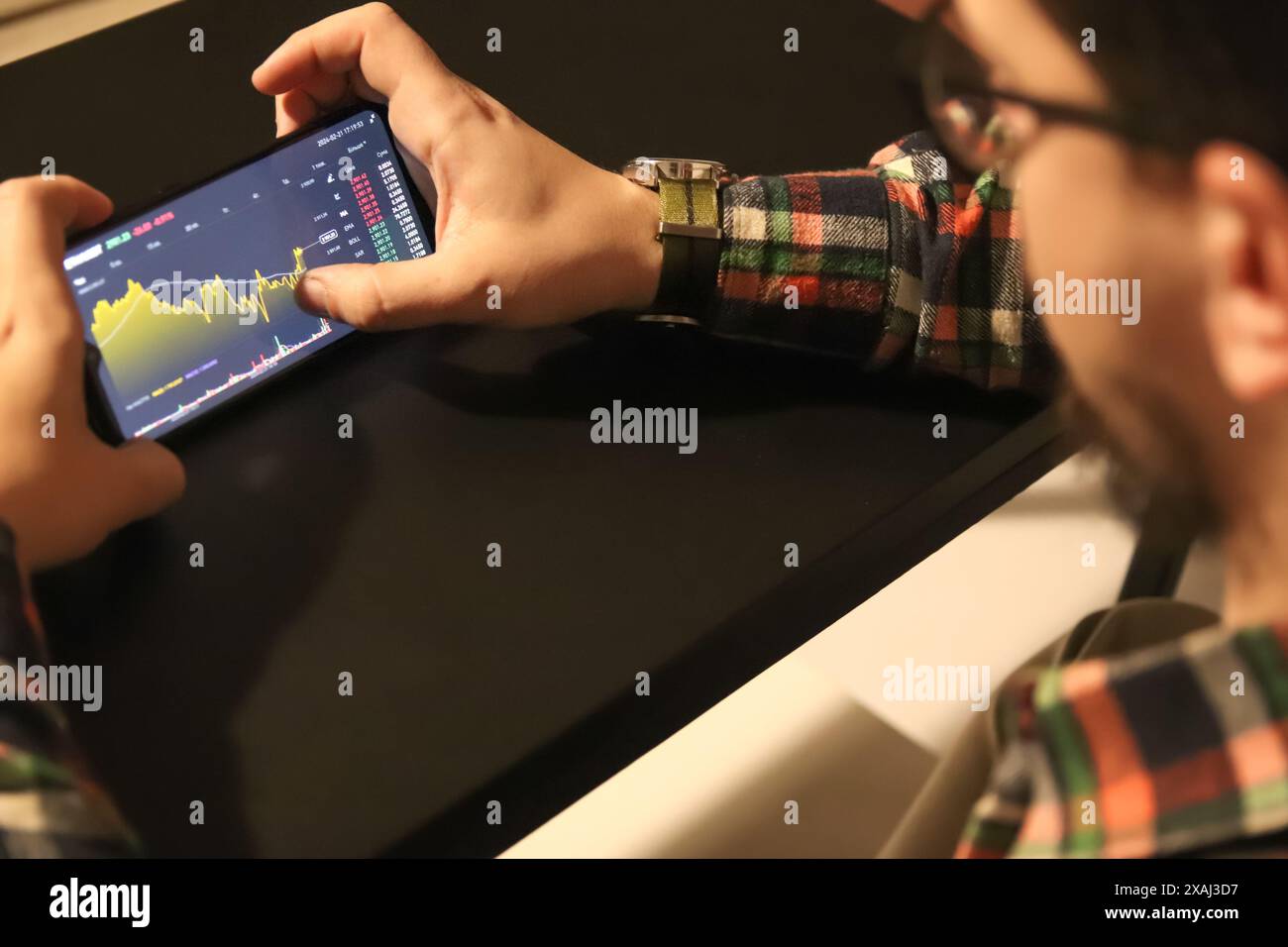 Man trading bitcoin on his phone with graph background. Businessman ...